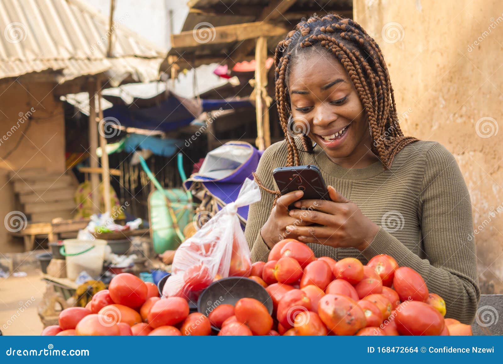 Beautiful Young African Woman in a Local African Market Viewing Content ... Beautiful Young African Woman in a Local African Market Viewing Content ...