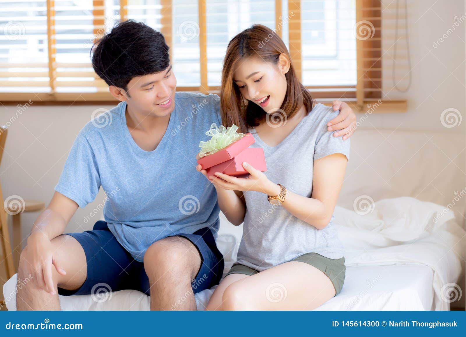 Beautiful Young Asian Couple in Love Surprise Gift Box in Bedroom at ... Beautiful Young Asian Couple in Love Surprise Gift Box in Bedroom at ...