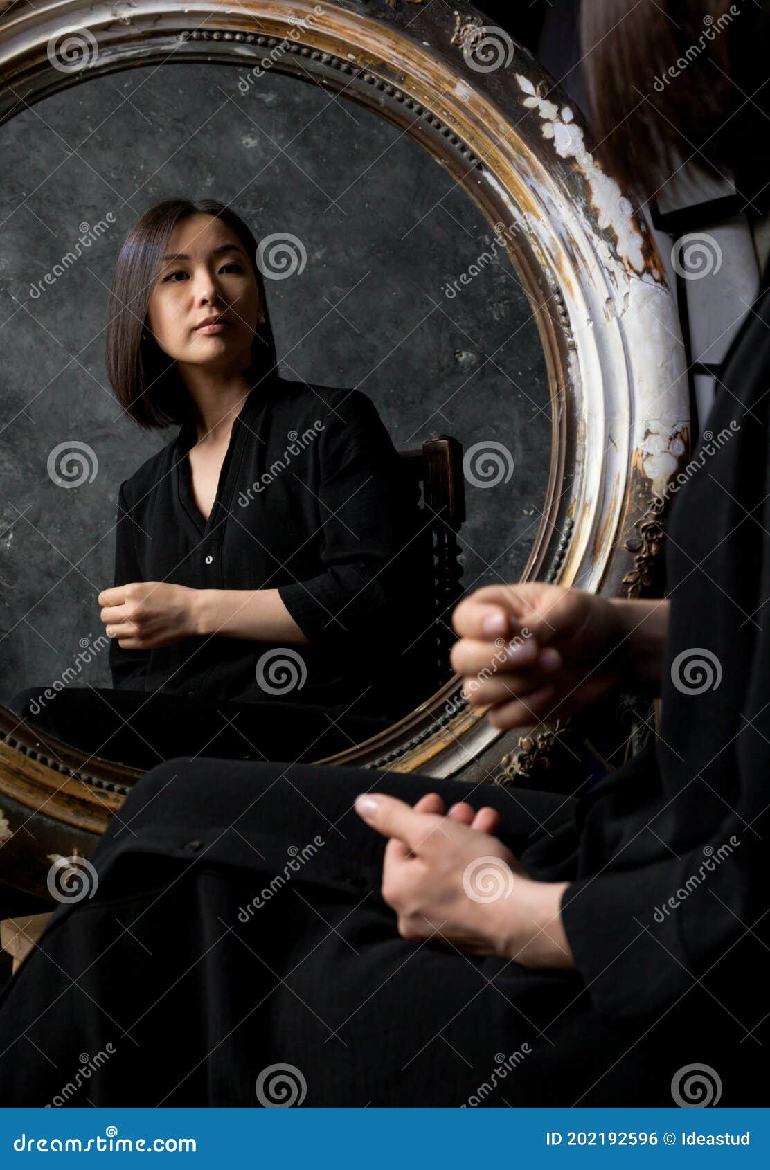 Beautiful Young Asian Woman Looking on Her Reflection at the Mirror ...