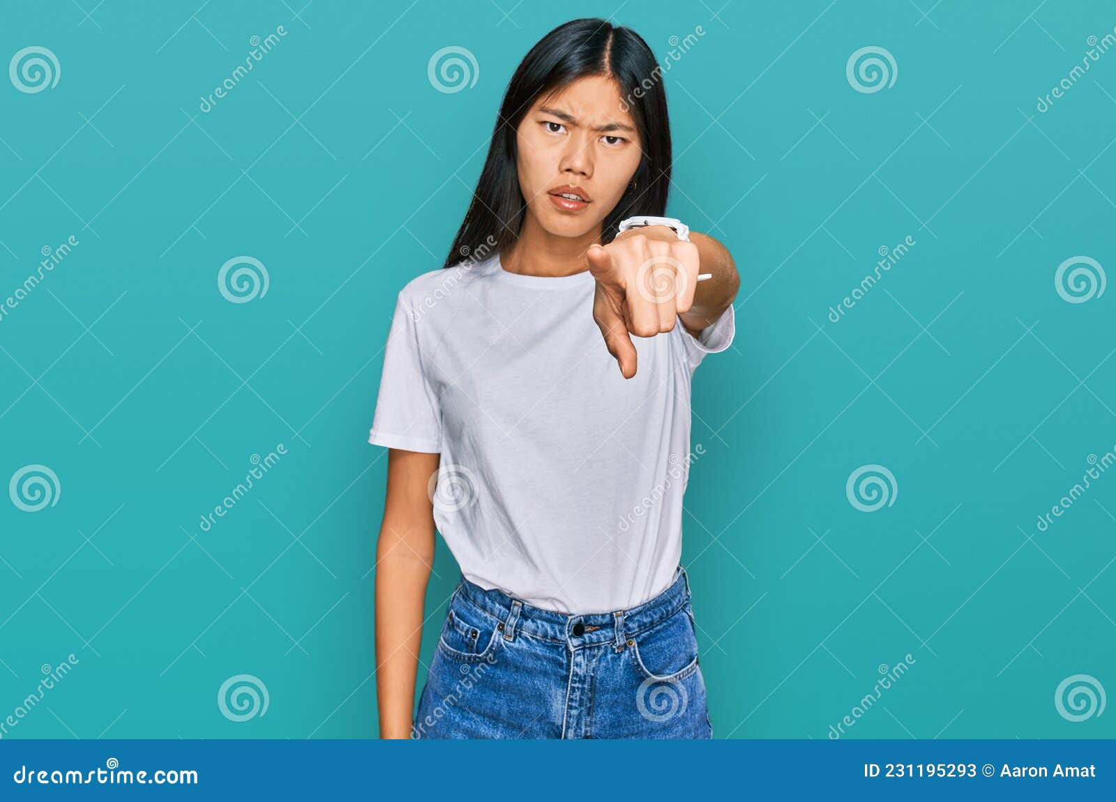 Beautiful Young Asian Woman Wearing Casual White T Shirt Pointing