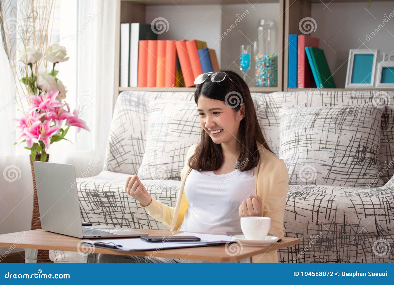 Beautiful Young Asian Woman Working On Laptop Computer While Sitting