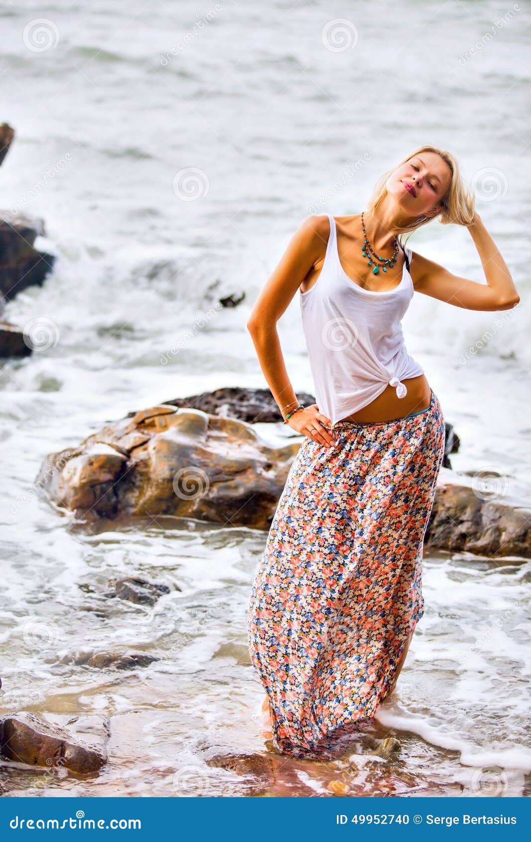 Beautiful Young Blonde Woman Posing Outdoor At The Rocky Sea Shore