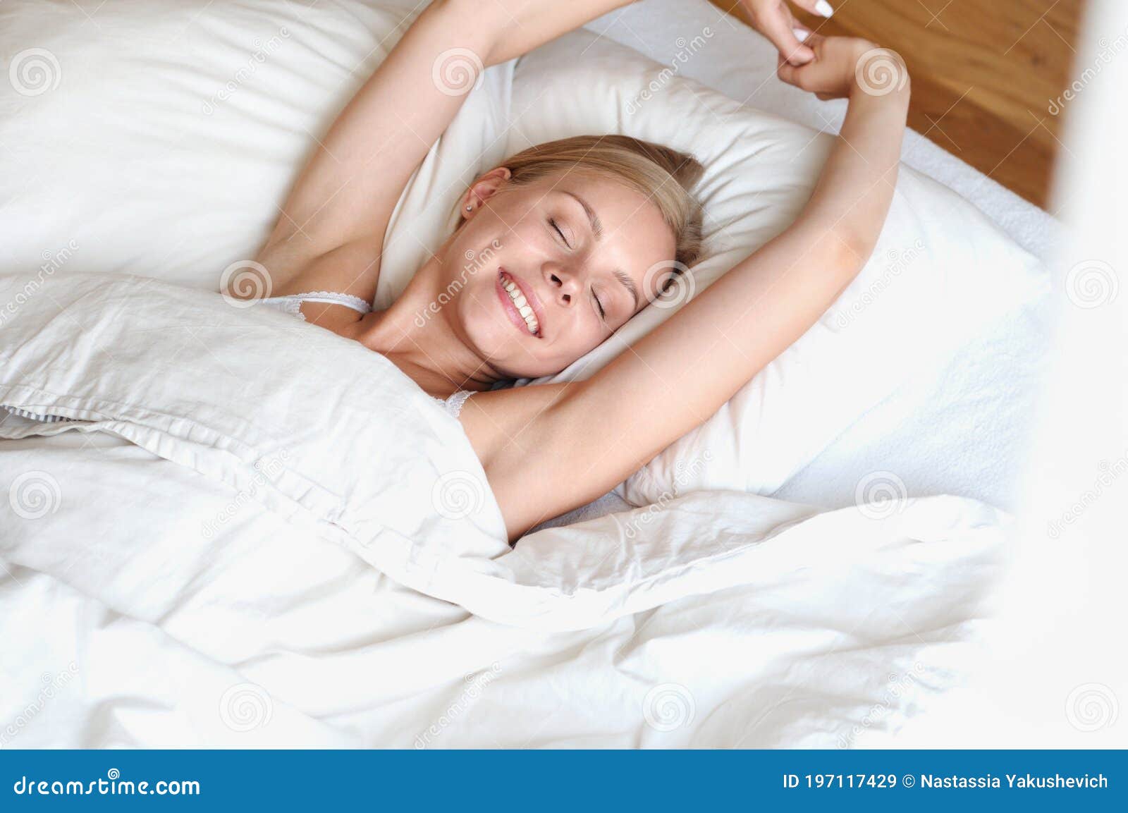 Beautiful Young Blonde Woman Waking Up And Stretching In The Morning In