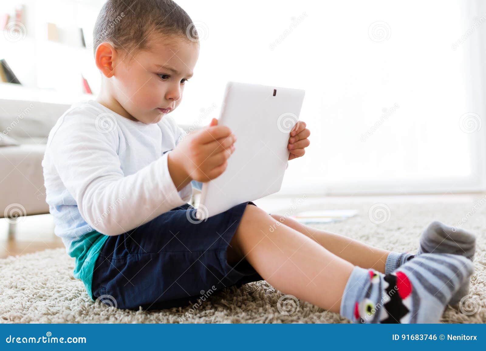 Beautiful Young Boy Using His Digital Tablet at Home. Stock Photo ...
