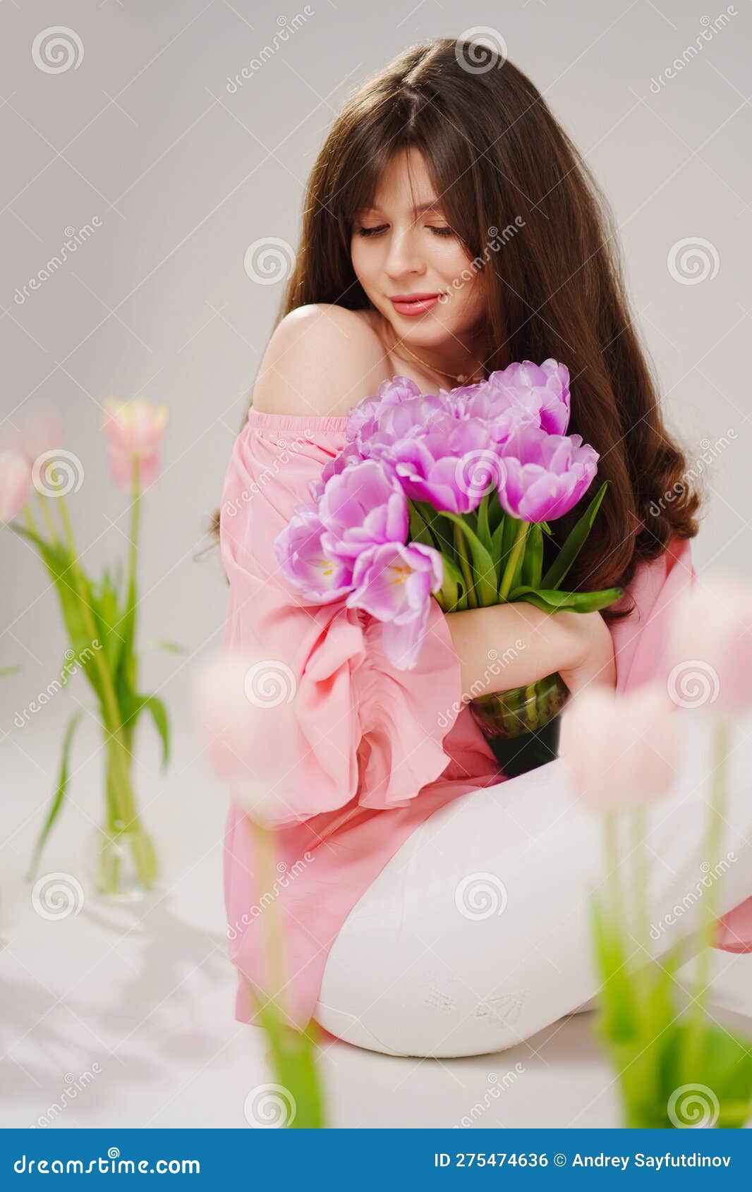 Beautiful Brunette Woman With Long Hair Sits On The Floor With Vases Of