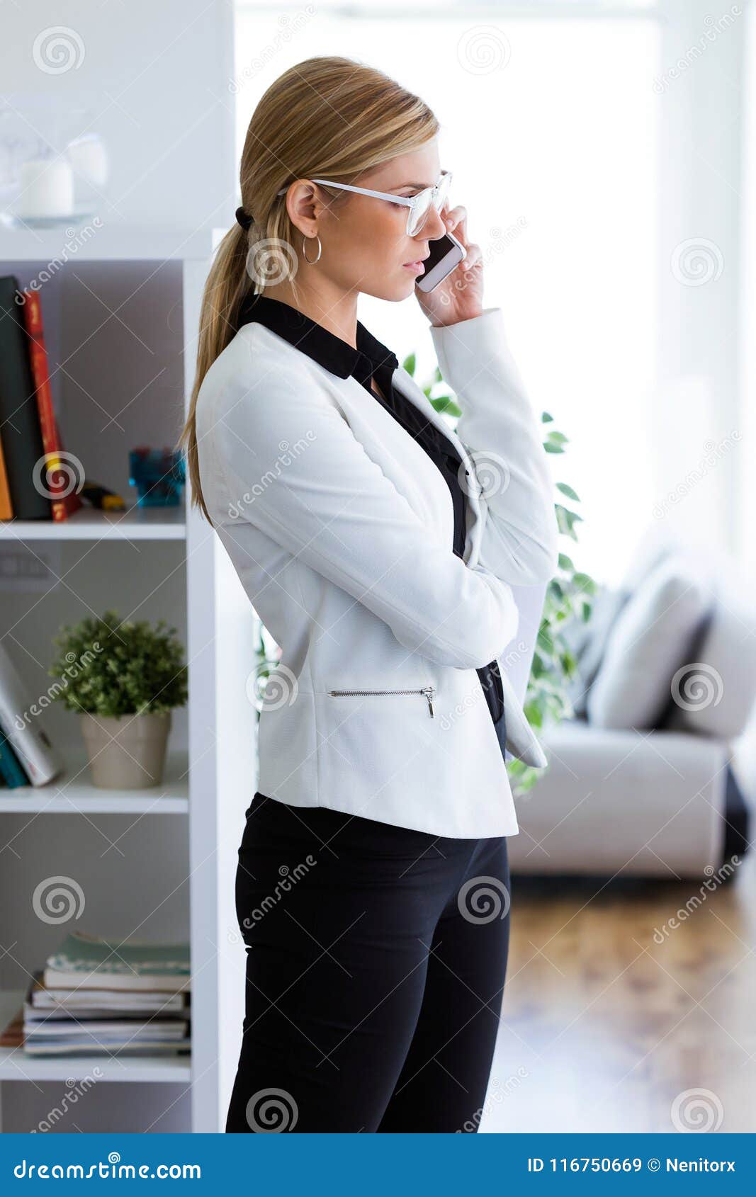Beautiful Young Businesswoman Using Her Mobile Phone in the Office ... Beautiful Young Businesswoman Using Her Mobile Phone in the Office ...