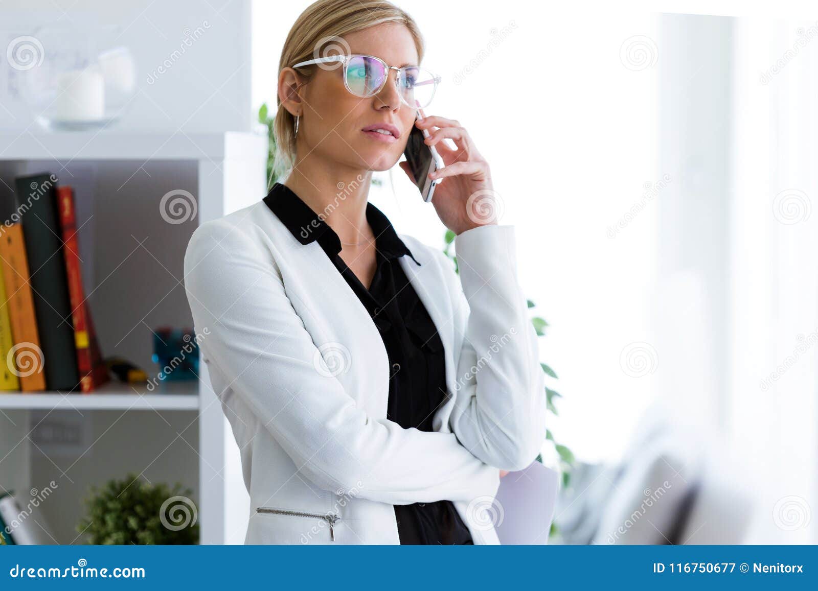 Beautiful Young Businesswoman Using Her Mobile Phone in the Office ... Beautiful Young Businesswoman Using Her Mobile Phone in the Office ...