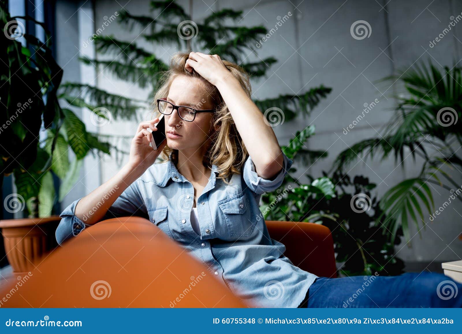 Beautiful Young Businesswoman Using Mobile Phone While Working Stock