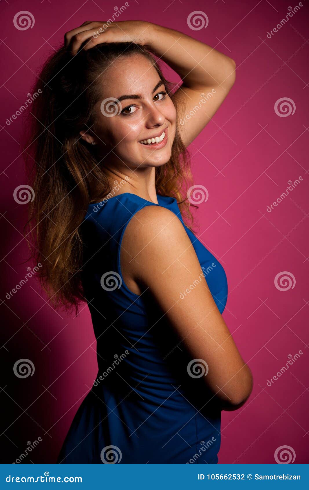 Beautiful Young Caucasian Woman In Blue Dress Isolate Over Pink Stock