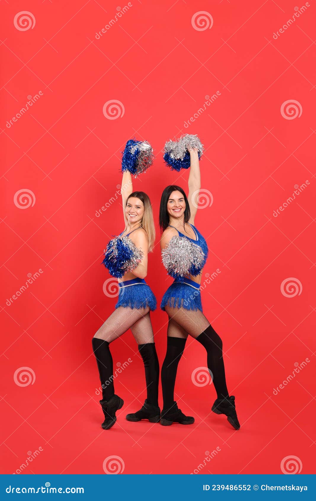 Beautiful Young Cheerleaders Dancing on Red Background Stock Photo ...