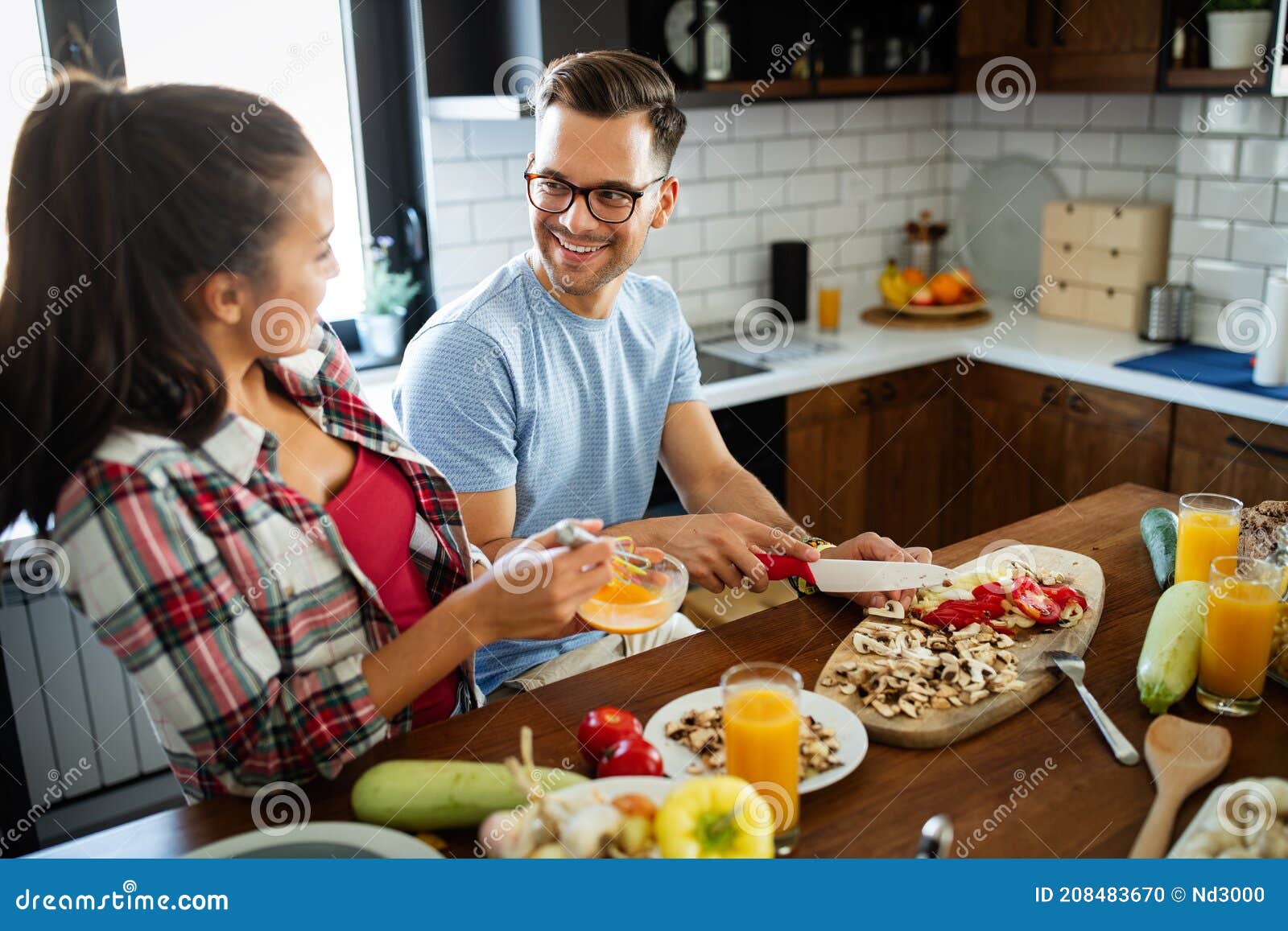 Beautiful Young Couple Having Fun in the Kitchen while Cooking. Stock ...