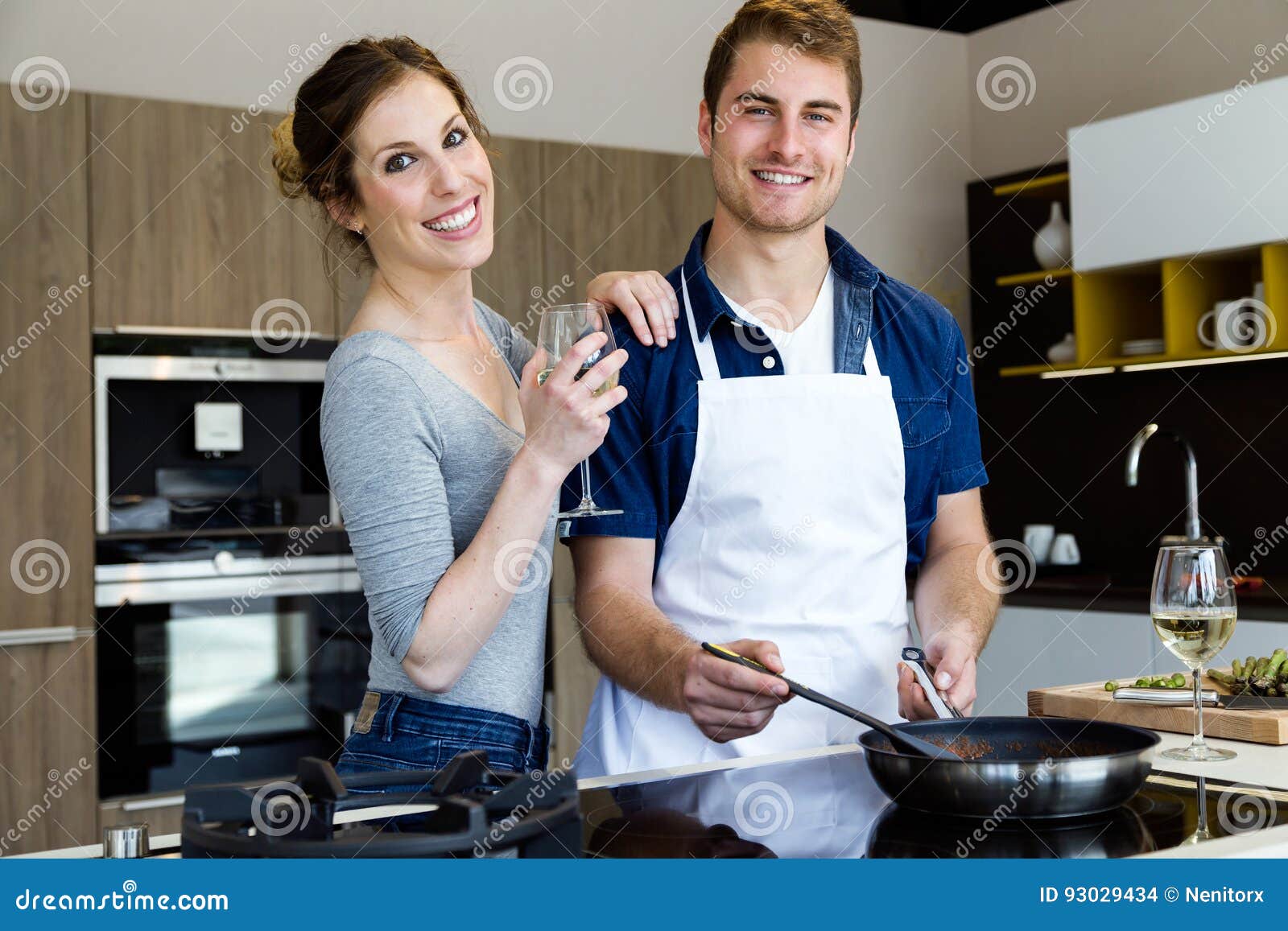 Beautiful Young Couple Looking at Camera in the Kitchen at Home. Stock ...