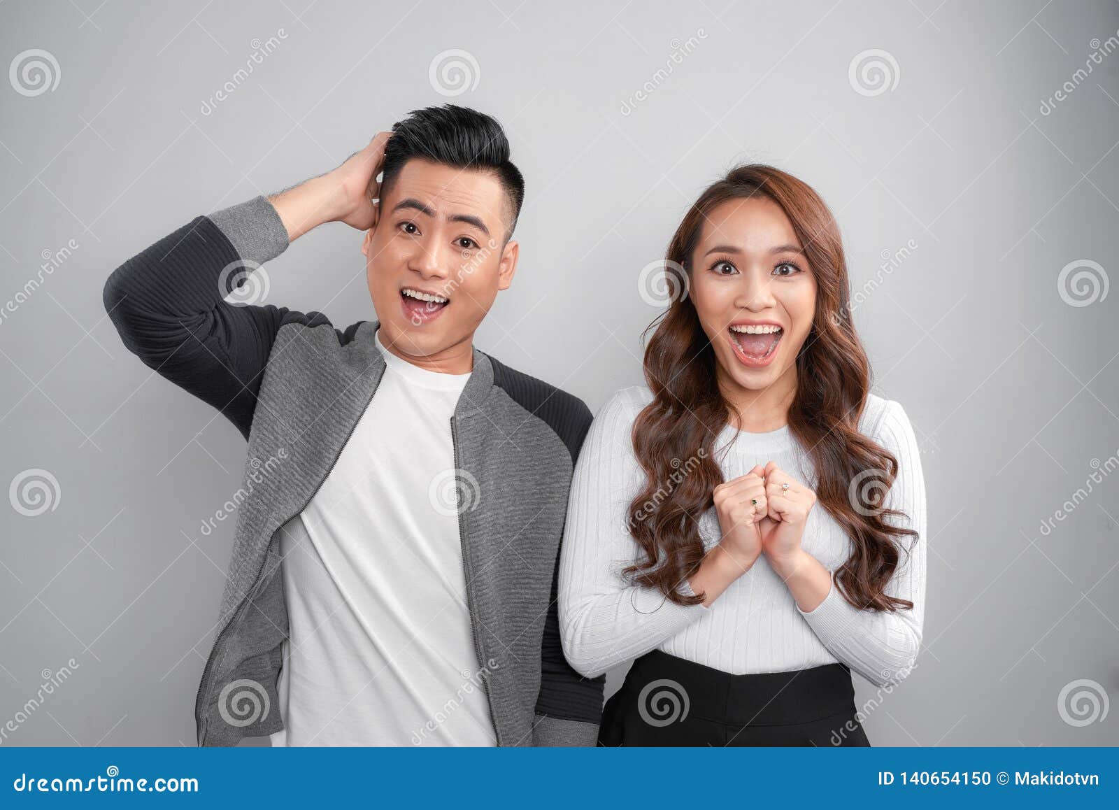 A Beautiful Young Couple Standing and Feeling Surprised in a Studio ...