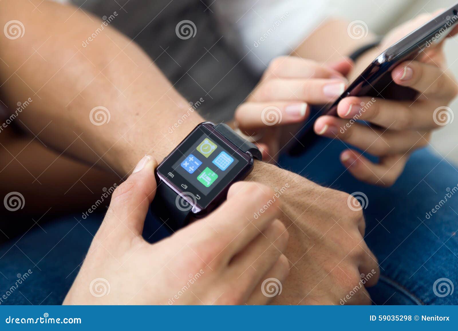 Beautiful Young Couple Using a Smartwatch at Home. Stock Photo - Image ...