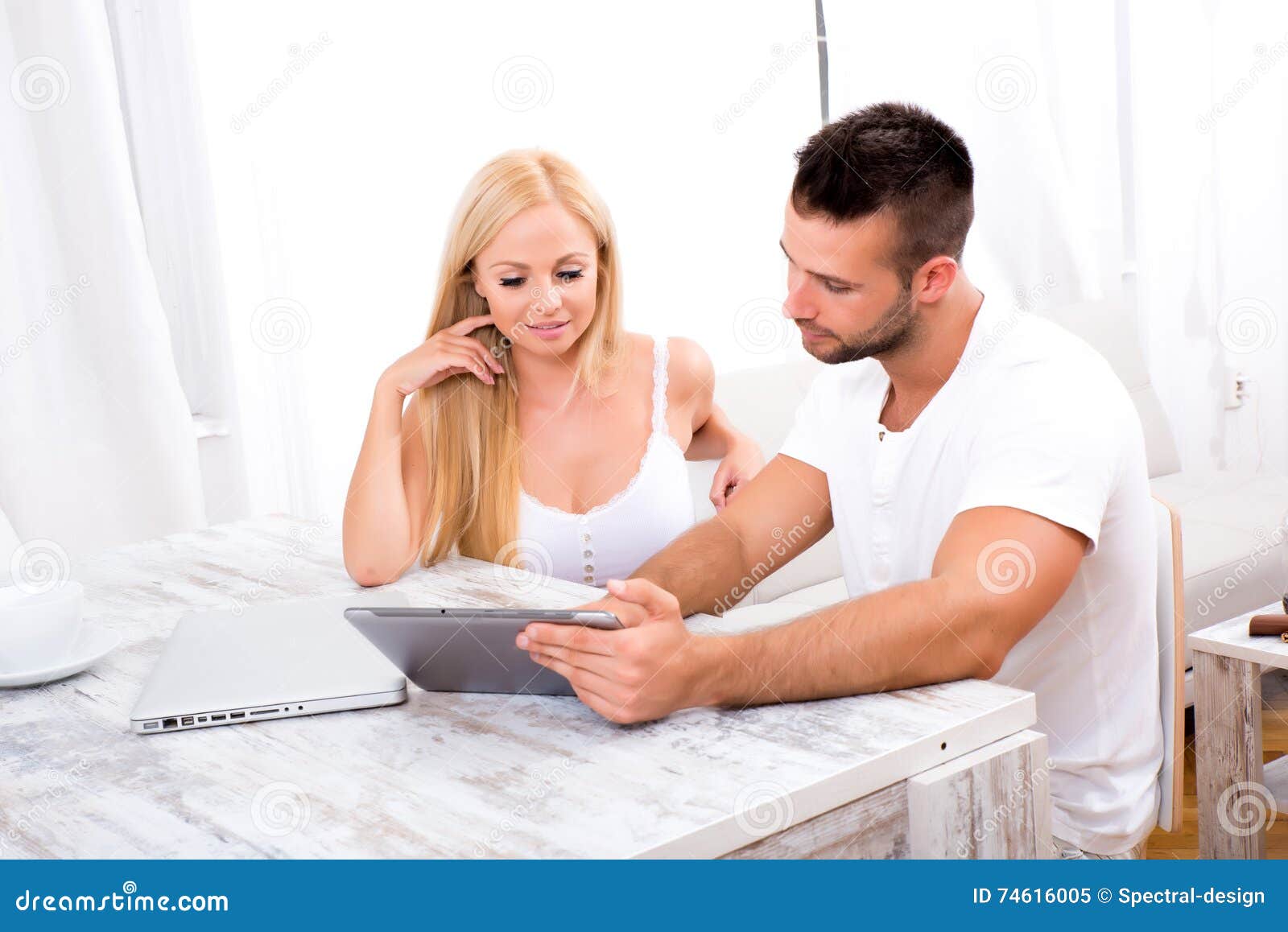 A Beautiful Young Couple Using a Tablet PC Together Stock Image - Image ...