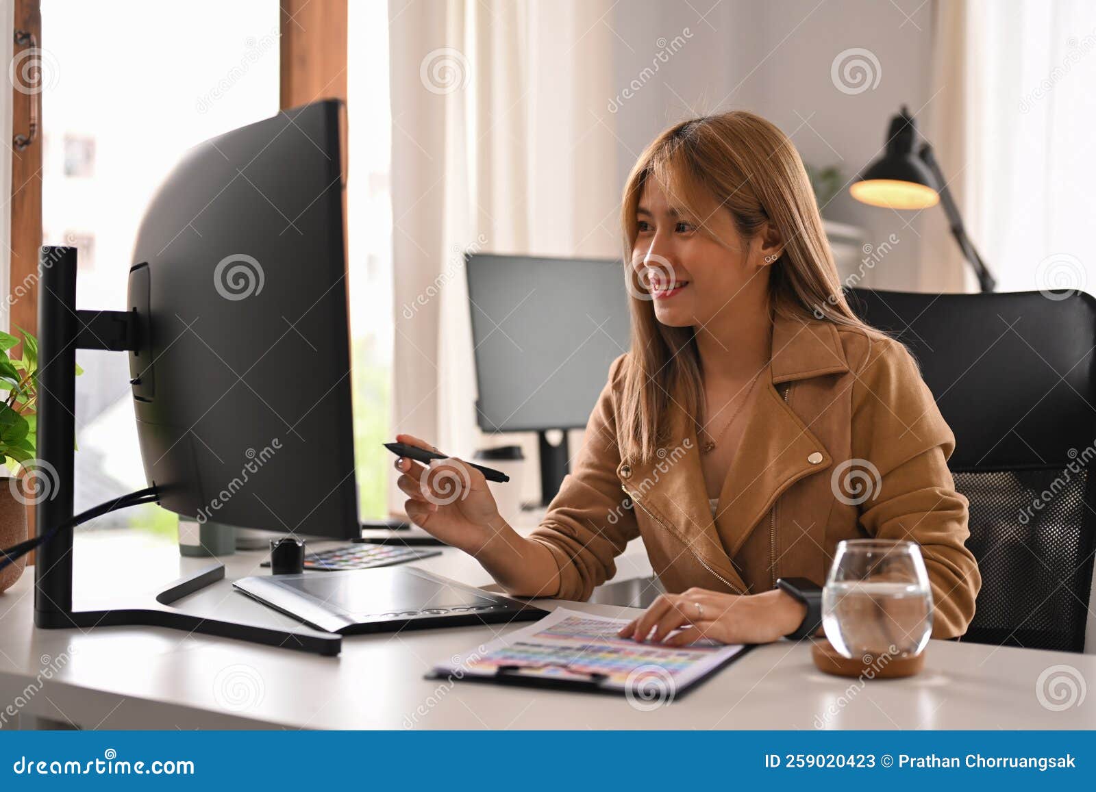 Beautiful Young Creative Woman Looking at Computer Screen and Using ...