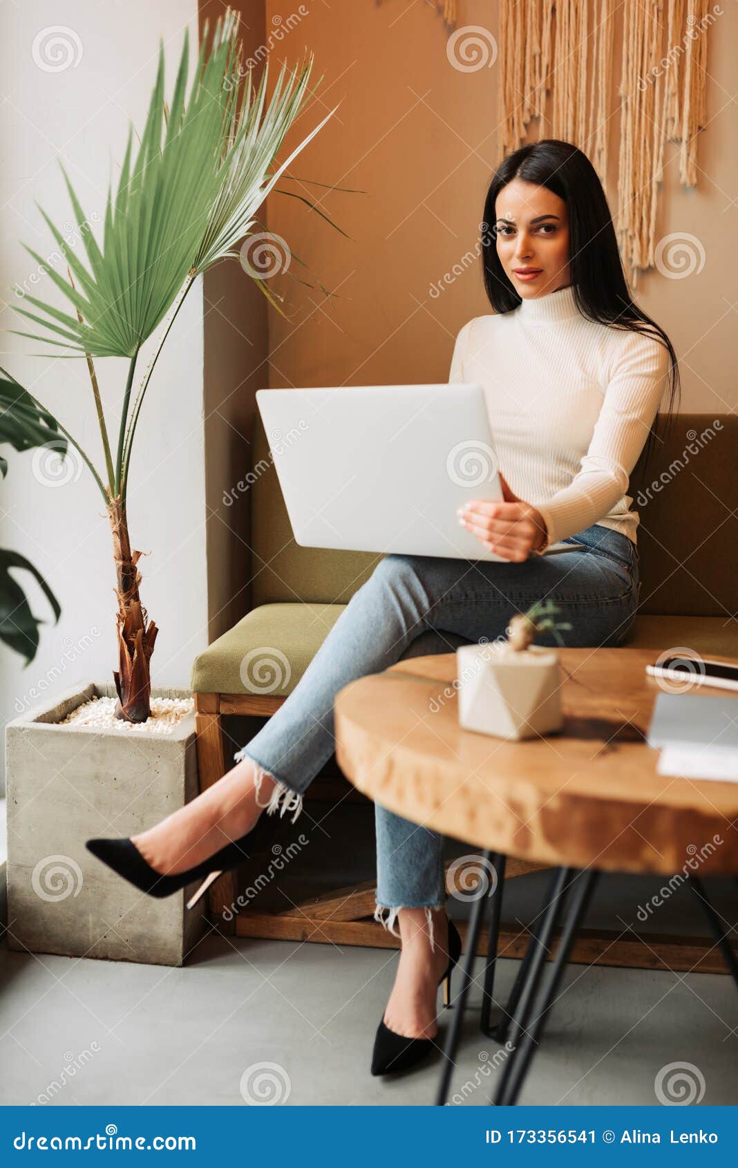 Beautiful Young Freelancer Woman Using Laptop Computer While Sitting At