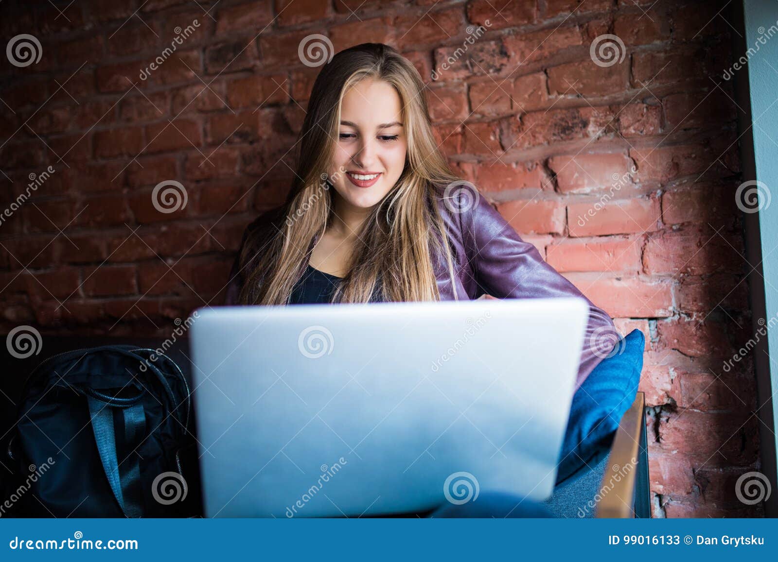 Beautiful Young Freelancer Woman Using Laptop Computer Sitting At Cafe