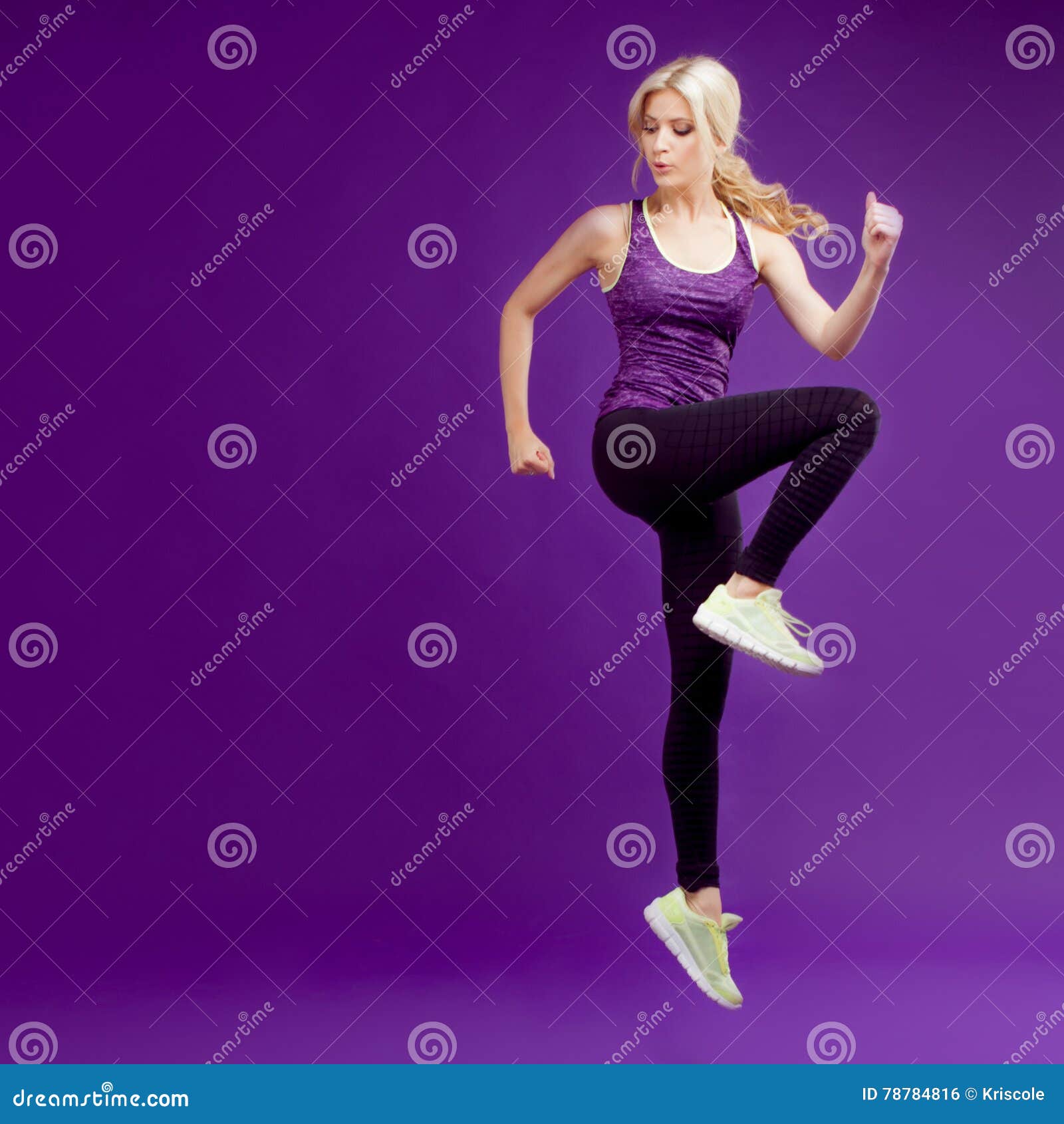 Beautiful Young Girl in a Pose Runner. Studio Background, Purple Stock ...