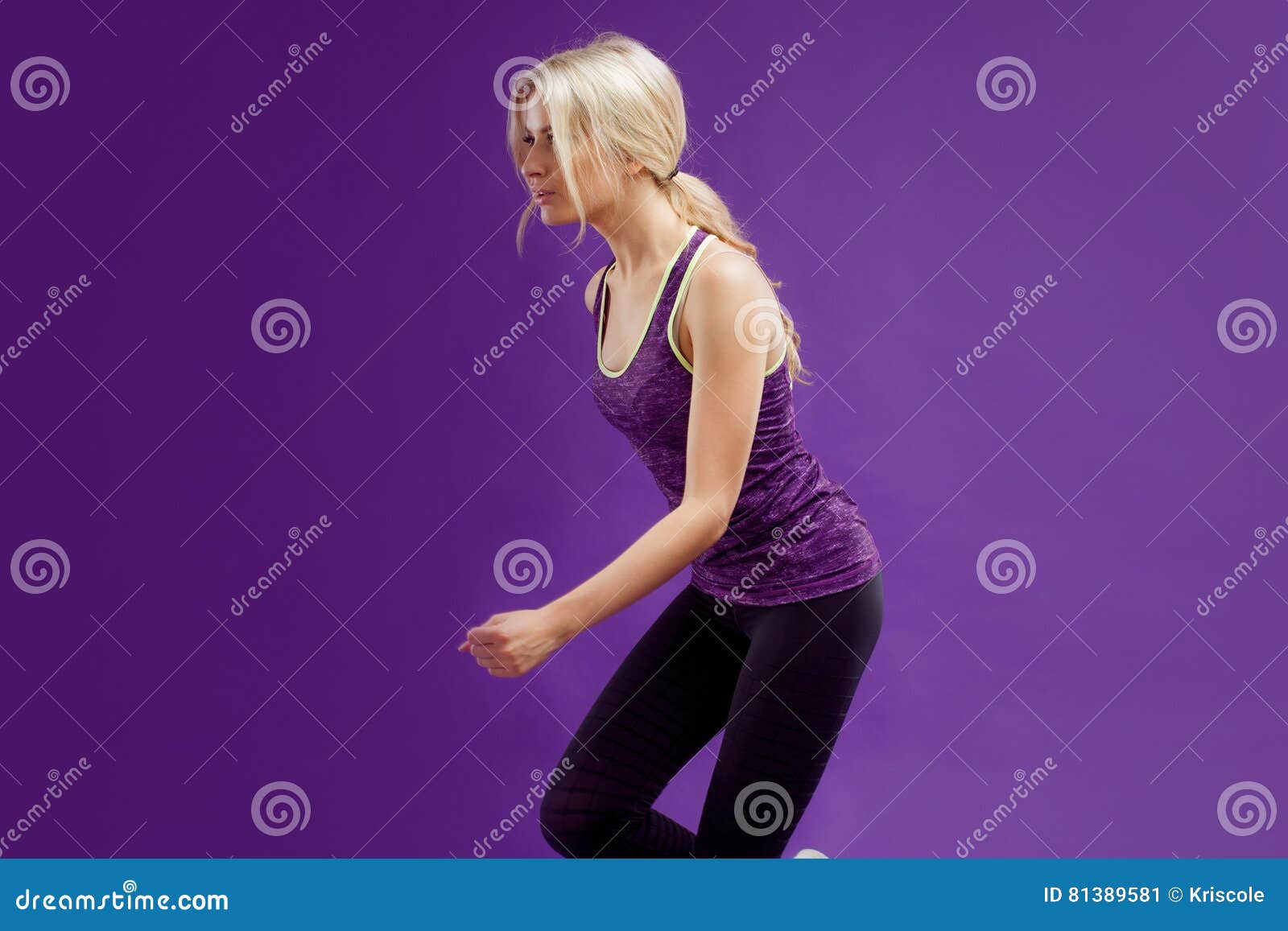 Beautiful Young Girl in a Pose Runner. Studio Background, Purple Stock ...