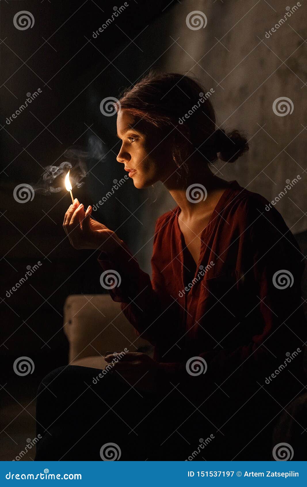 Beautiful Young Girl In Red Shirt Lights Up Her Pretty Face With Match