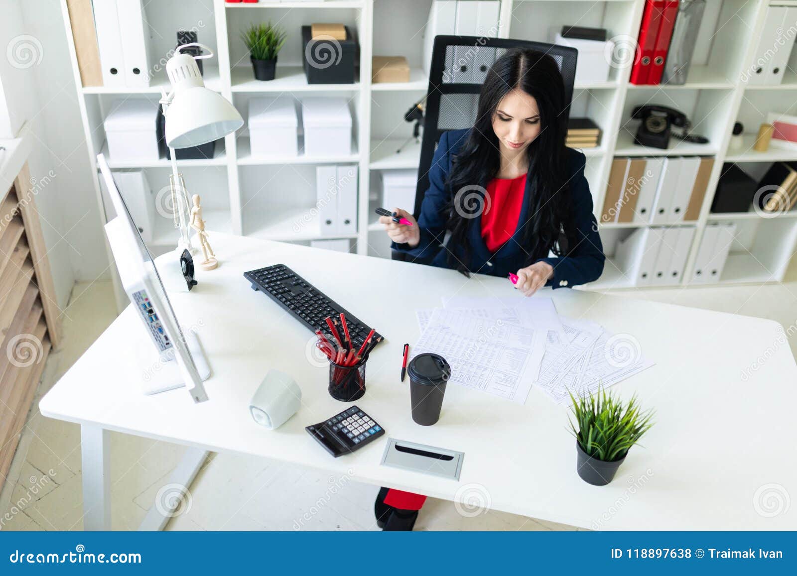 Beautiful Young Girl is Working with Documents in the Office at the ...