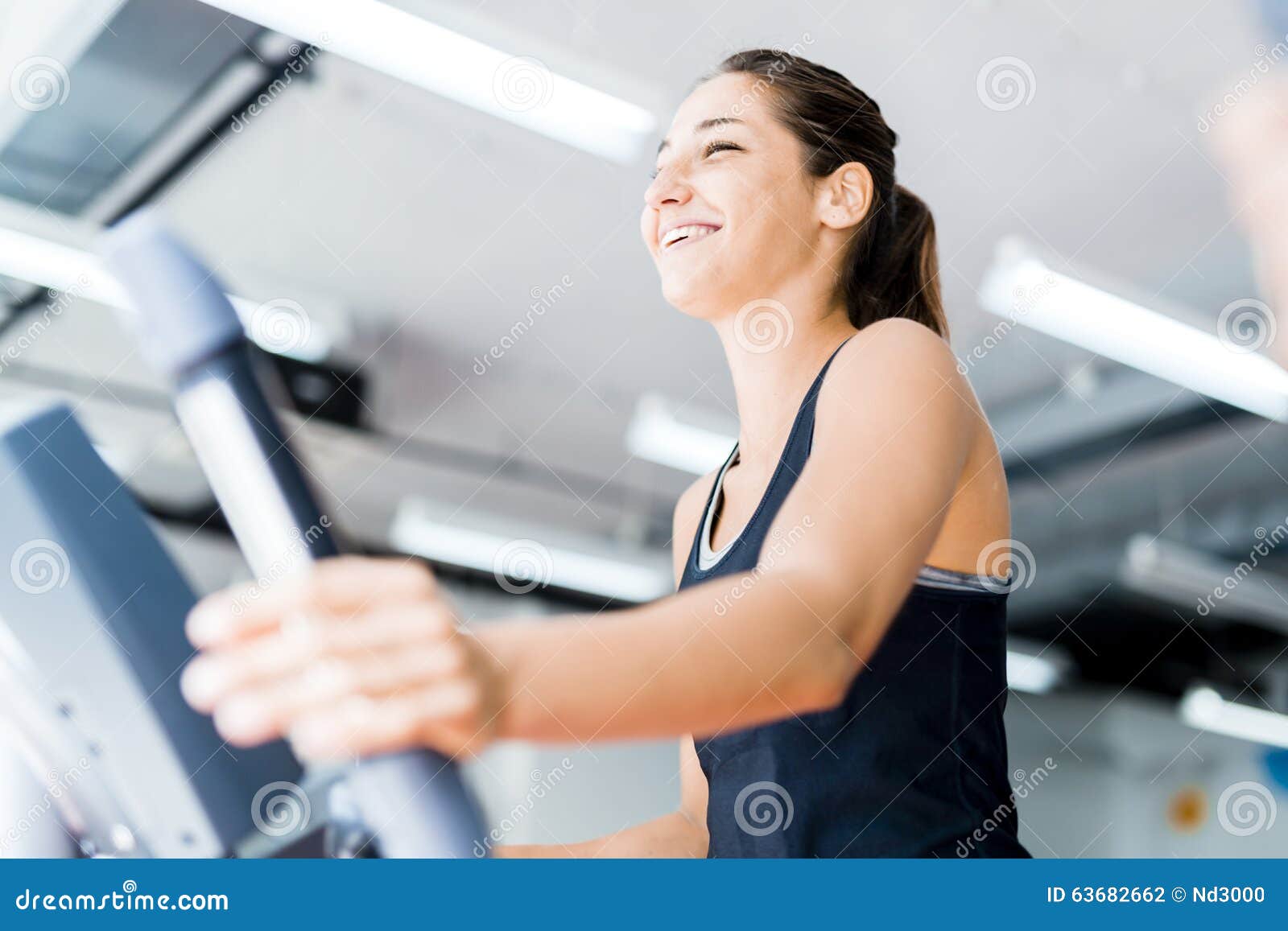 Beautiful Young Lady Using the Elliptical Trainer Stock Photo - Image ...
