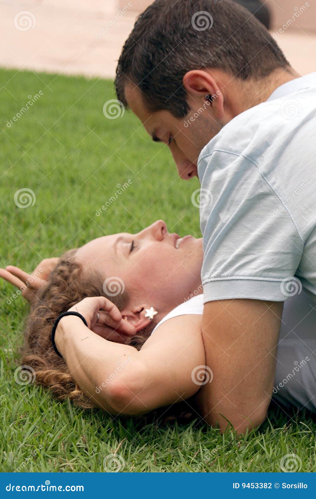 Beautiful Young Lovers Laying on the Grass Hugging Stock Photo - Image ...
