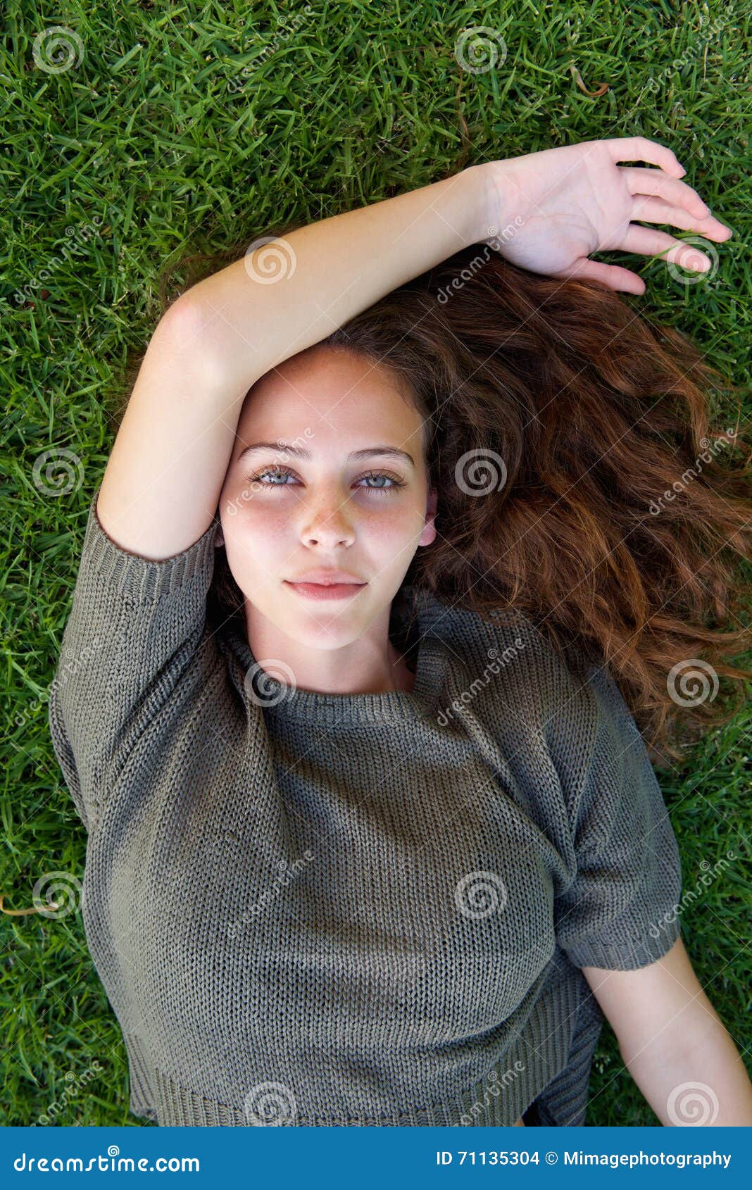 Beautiful Young Model Staring while Lying on Grass Stock Photo - Image ...