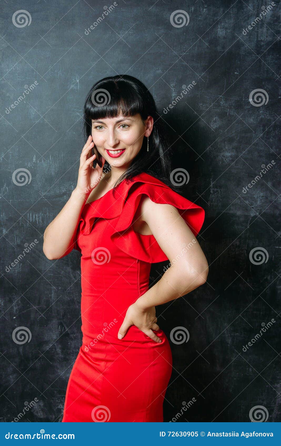 Beautiful Young Model Woman In Red Dress Posing Over Black Slate Stock