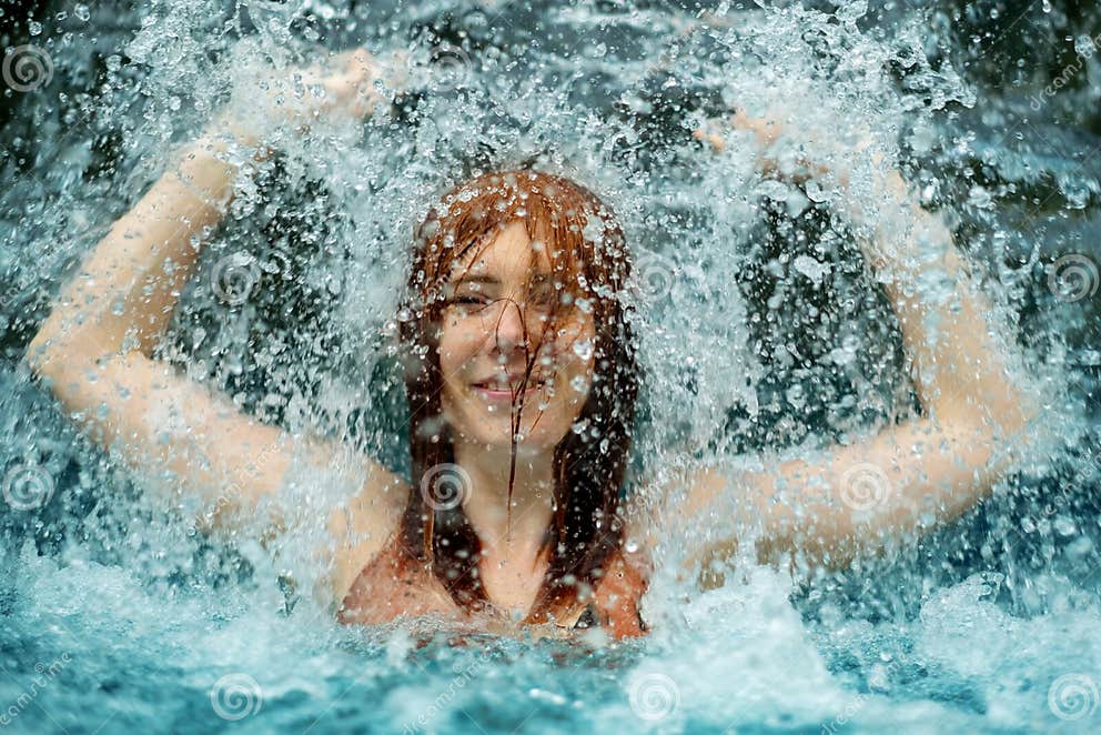 Beautiful Young Redhead Woman In Bikini Under The Splashing Water Of