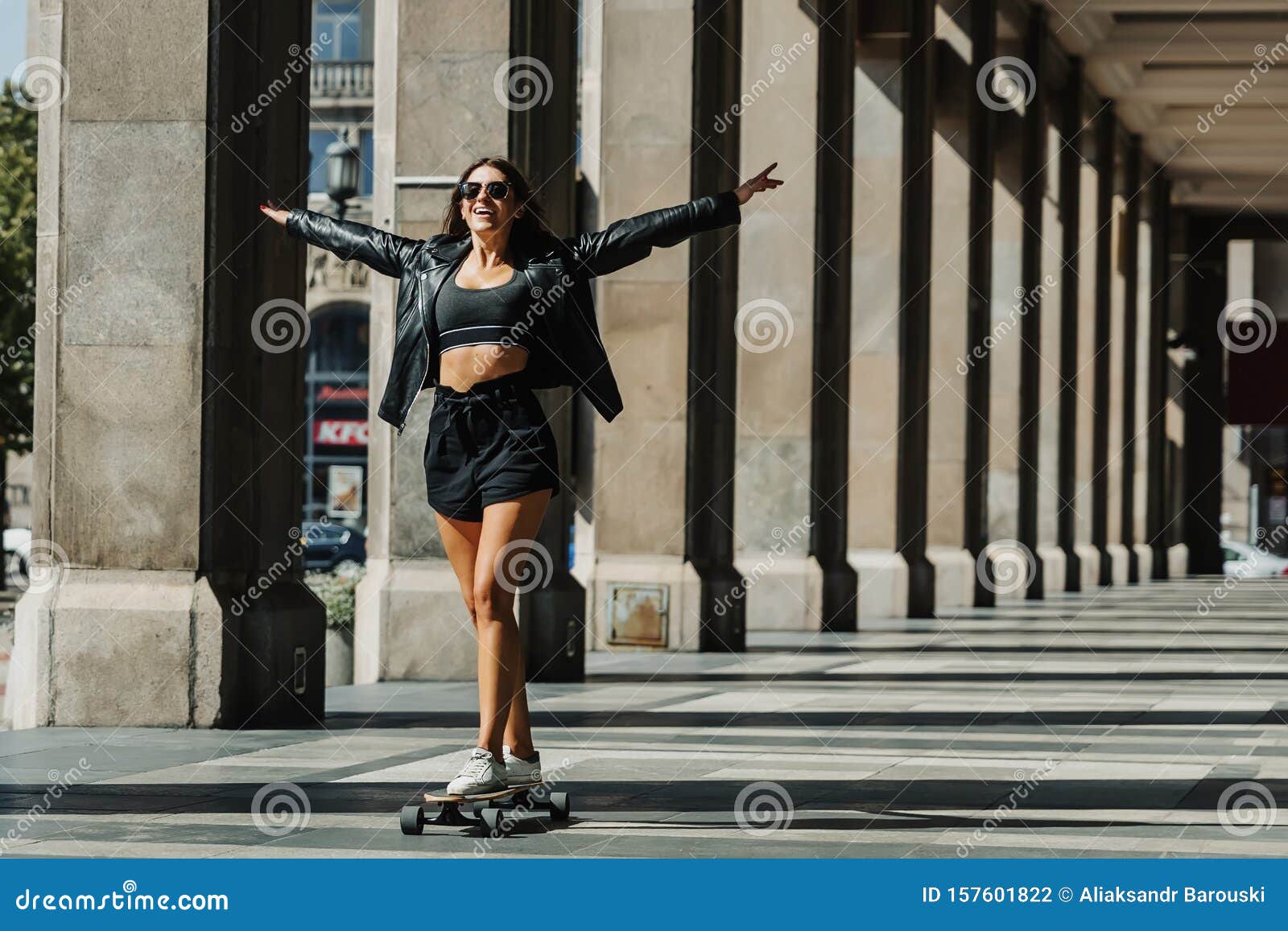 Beautiful Young Skater Woman Riding On Her Longboard In The City