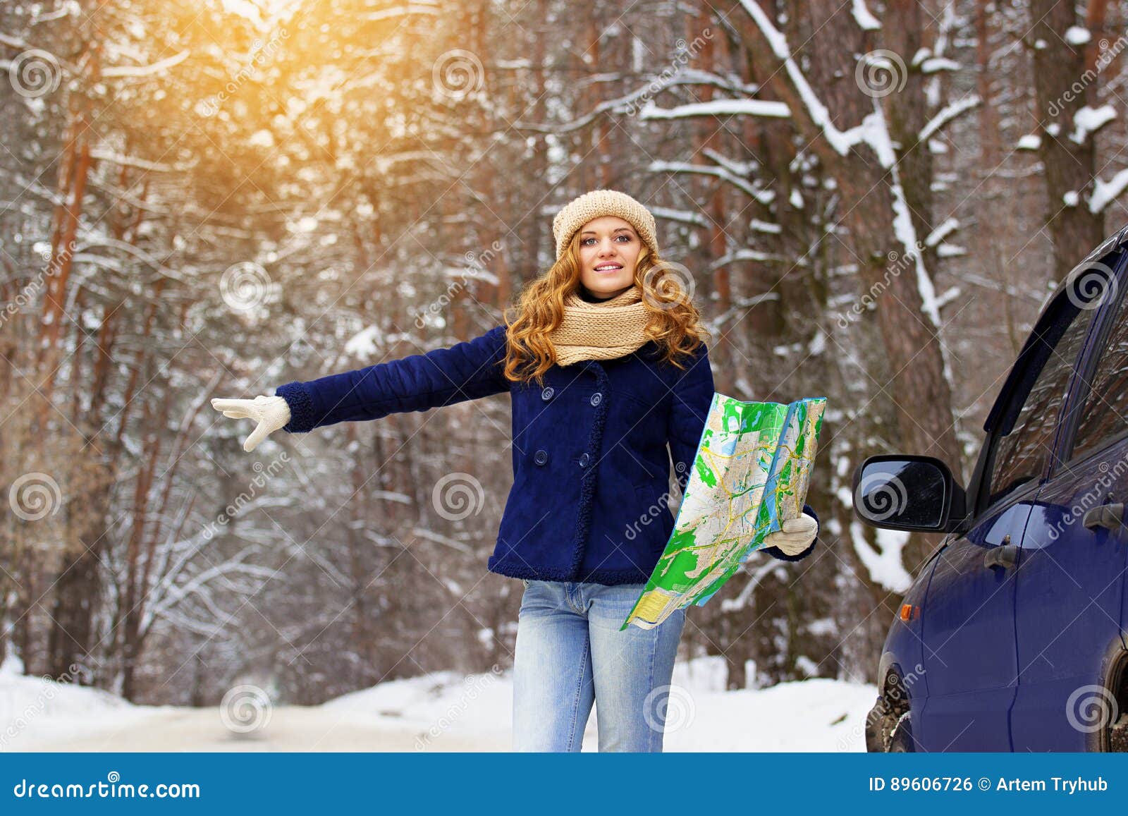 Beautiful Young Smiling Girl Hitchhiking On The Highway With Map In