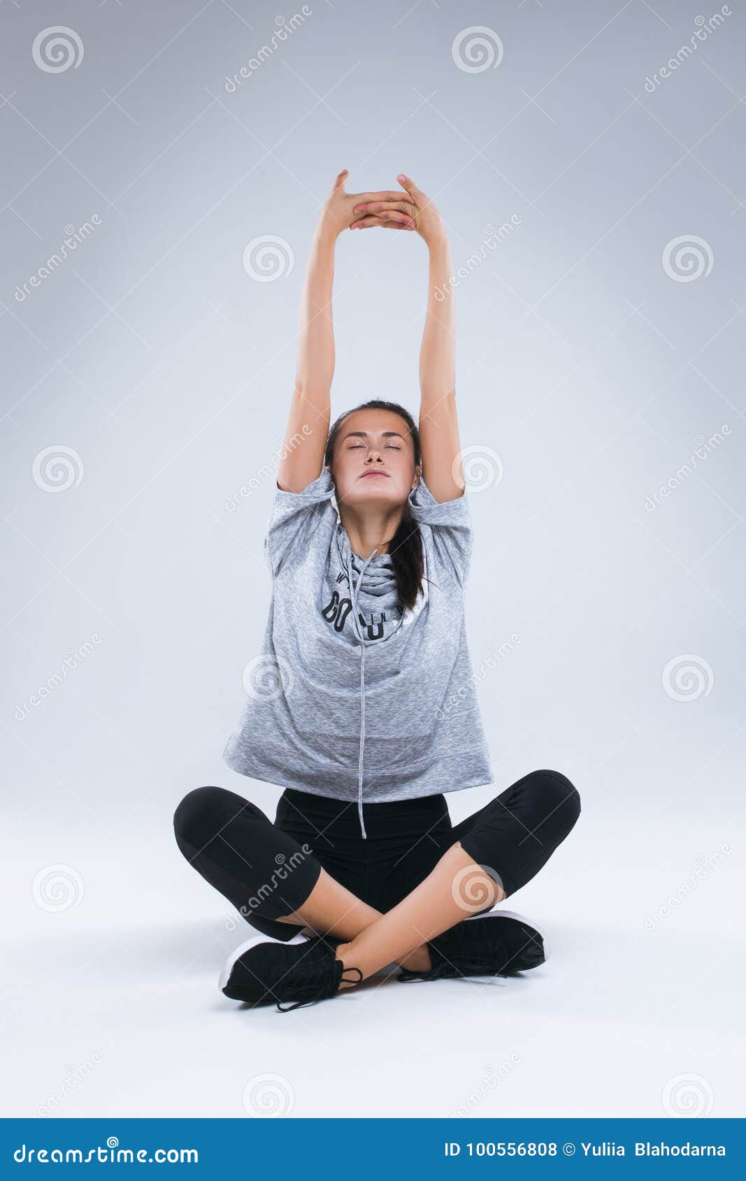 Beautiful Young Sport Woman Doing Yoga Exercises And Raised Her Hands