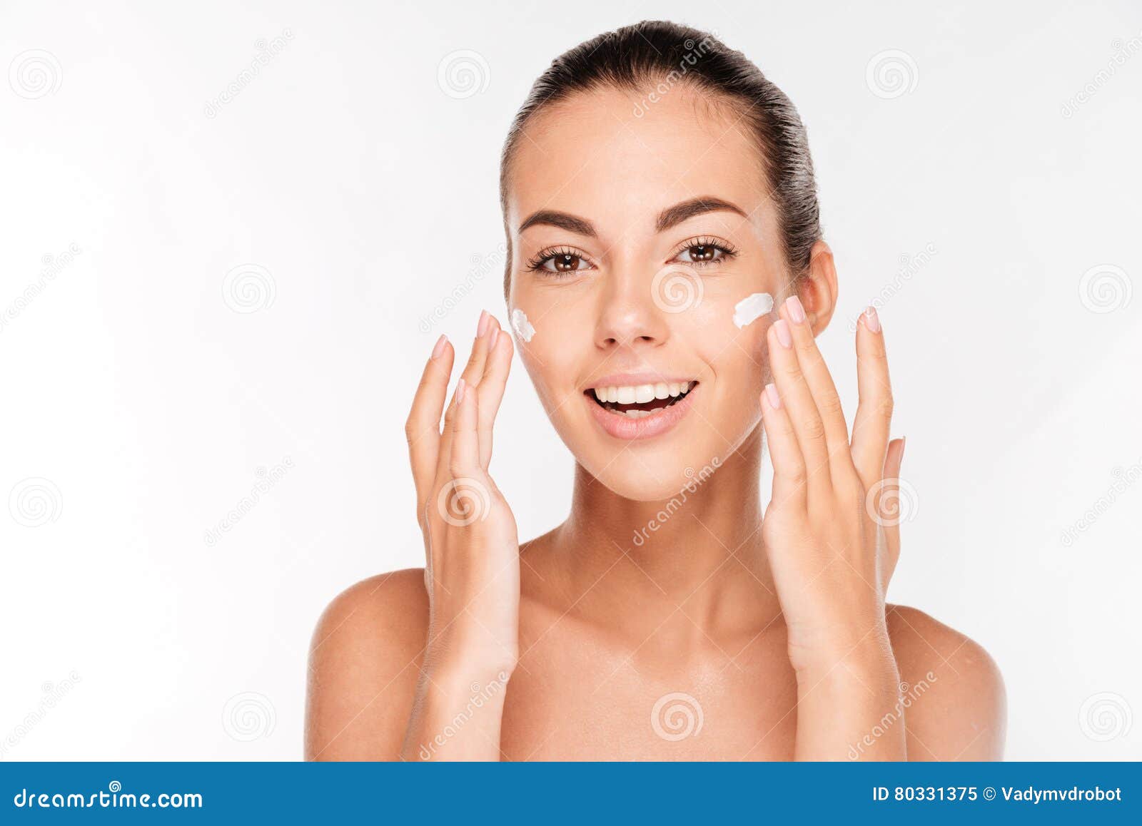 Beautiful Young Woman Applying Cosmetic Cream Treatment On Her Face