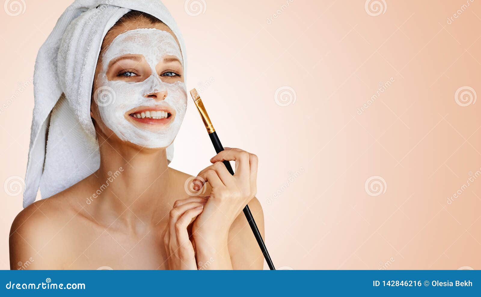 Beautiful Young Woman Applying Facial Mask On Her Face With Brush Skin
