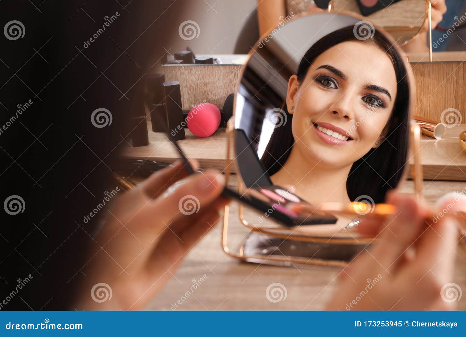 Beautiful Young Woman Applying Makeup Near Mirror At Table Stock Image