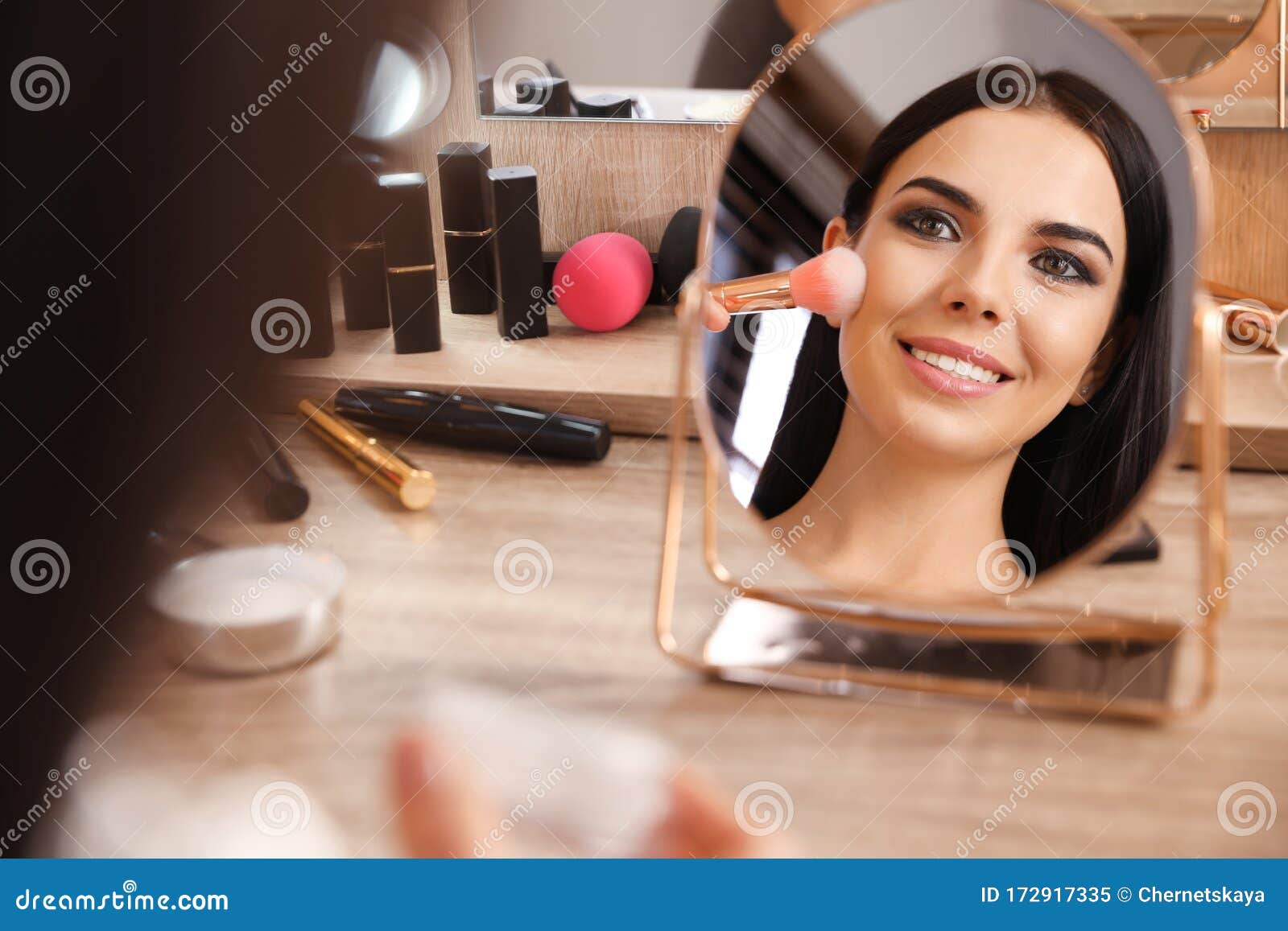 Beautiful Young Woman Applying Makeup Near Mirror At Table Stock Image