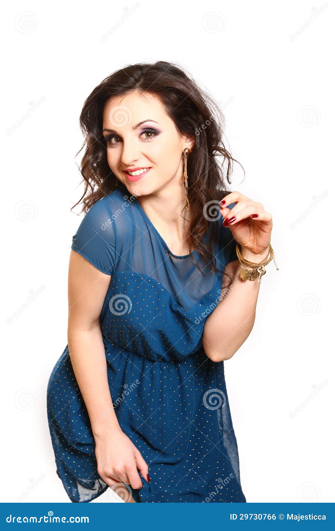 Beautiful Young Woman In A Blue Dress Posing On A White Background