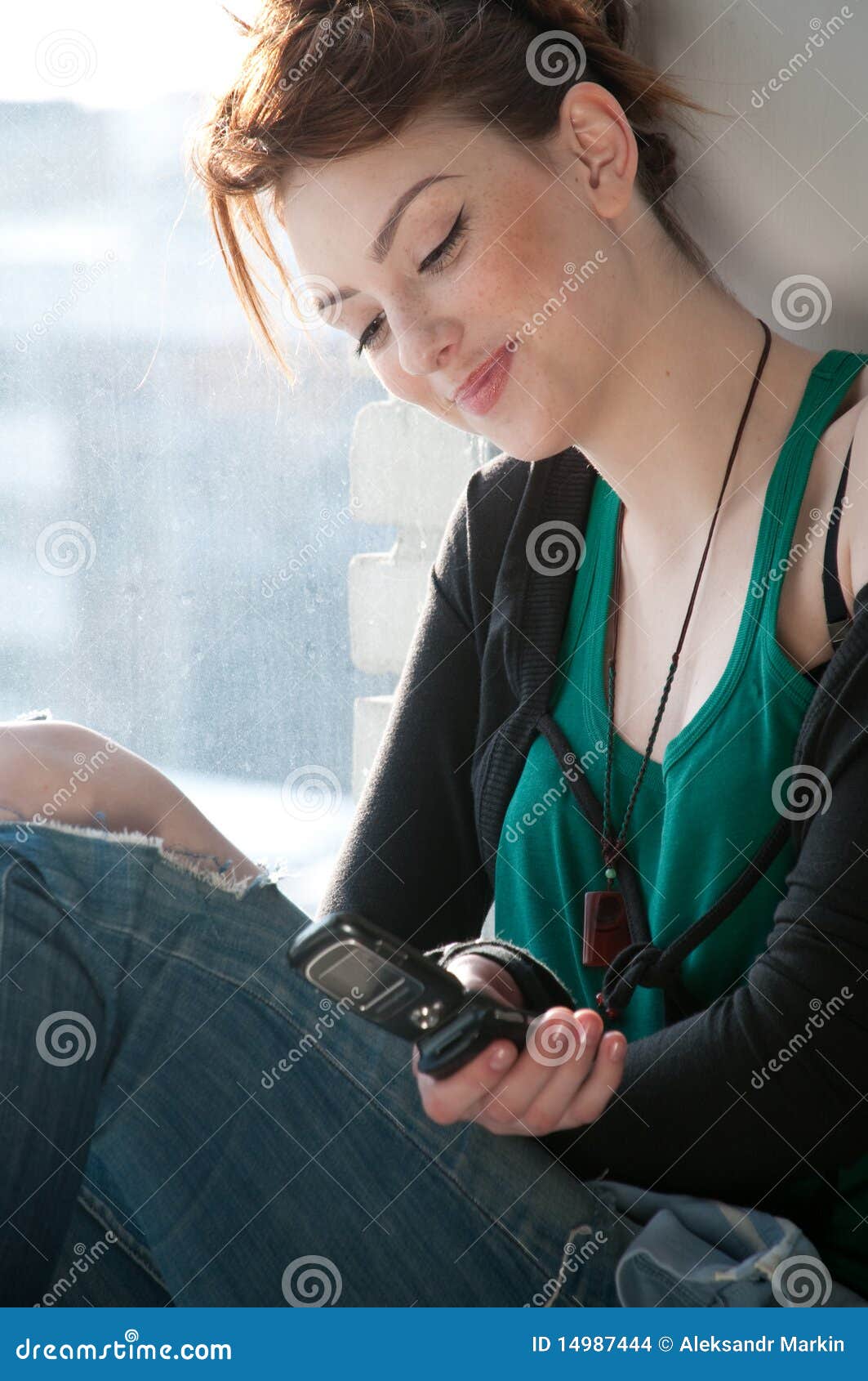 Beautiful Young Woman with Cell Phone on Window. Stock Photo - Image of ...