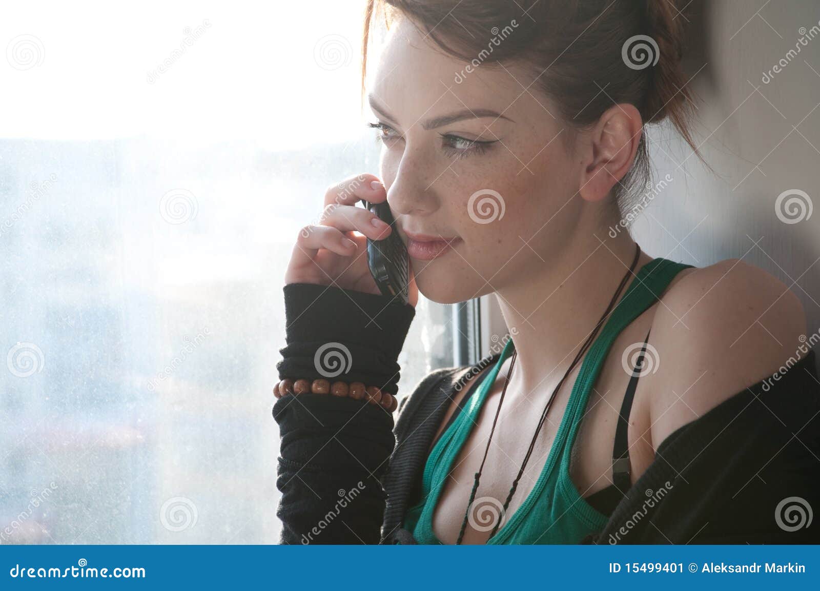 Beautiful Young Woman with Cell Phone on Window. Stock Image - Image of ...