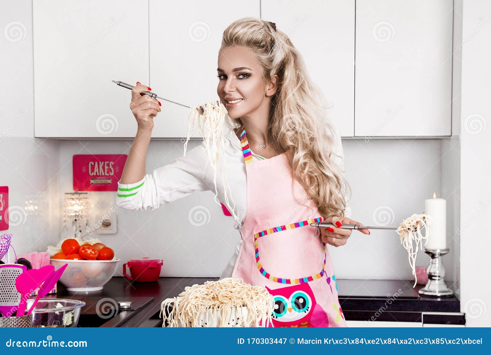 Beautiful Young Woman In Chef Apron Is Mixing Batter Looking At Camera And Smiling While Baking