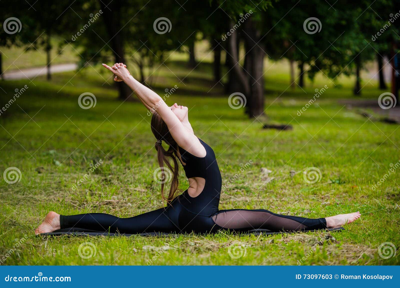 Beautiful Young Woman Doing Relaxing and Stretching Exercises in the ...