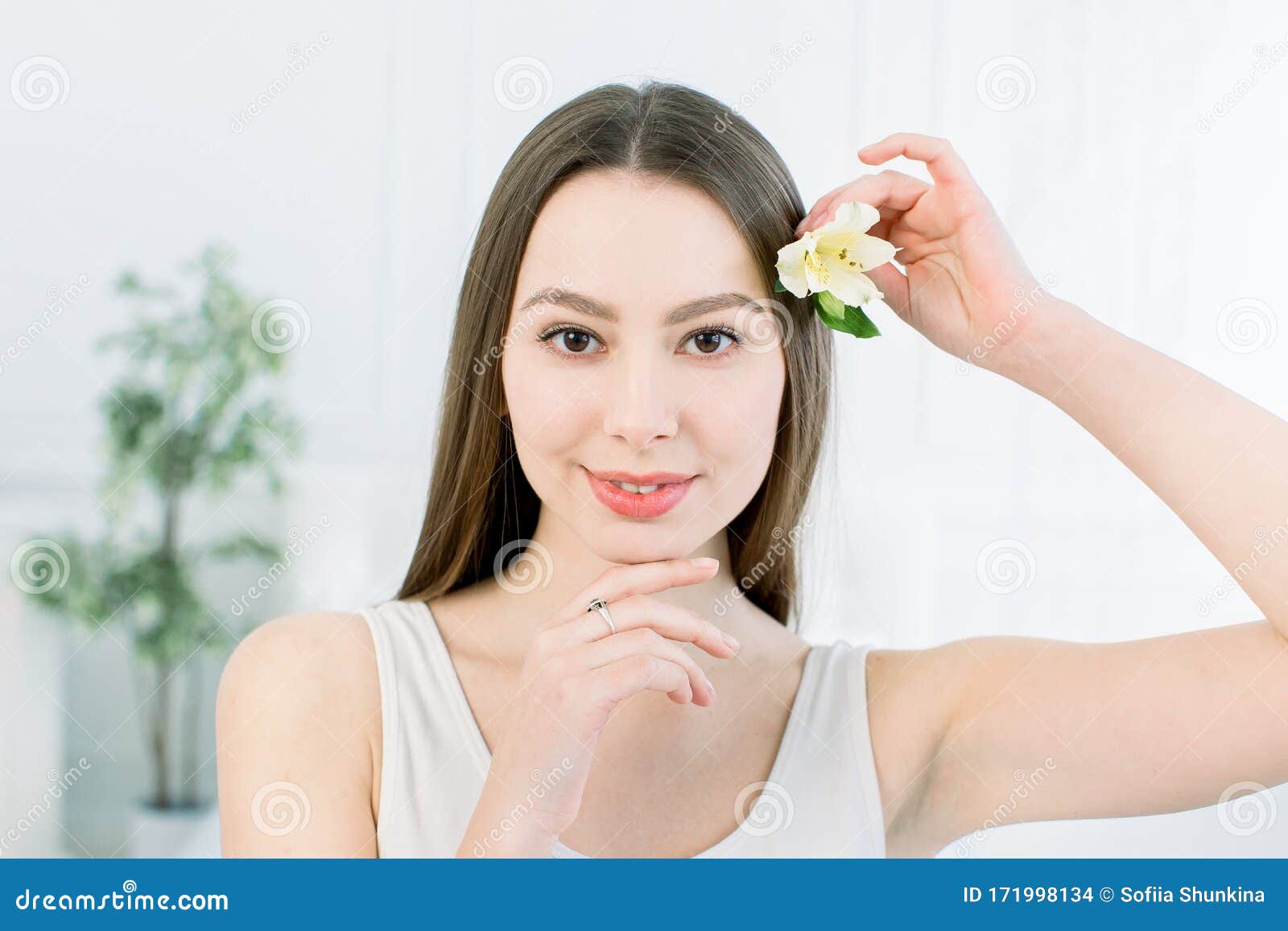 Beautiful Young Woman With Flower In Hand Near At Face Closeup