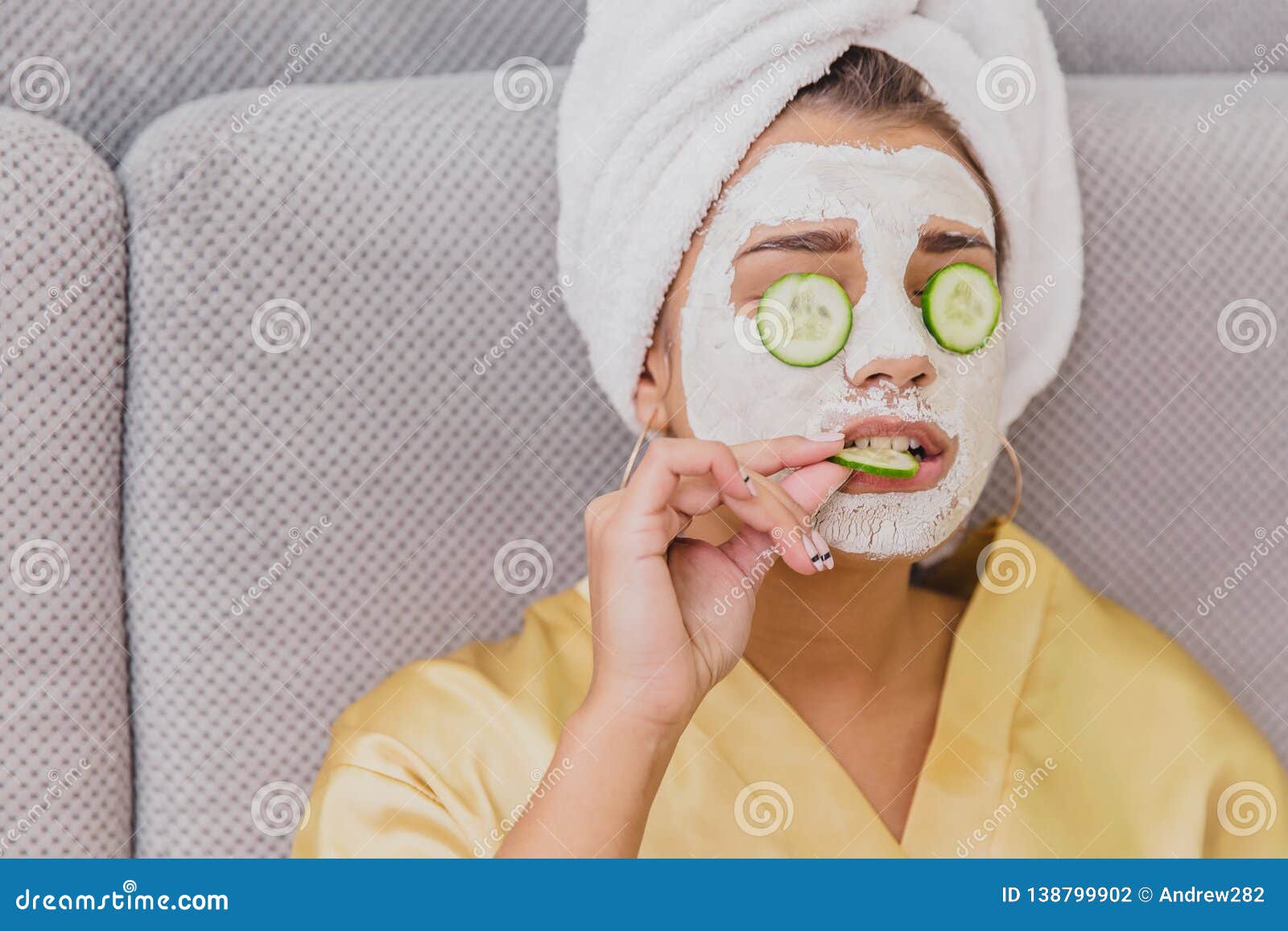 A Beautiful Young Woman Gets A Face Mask In The Spa Center Lying With