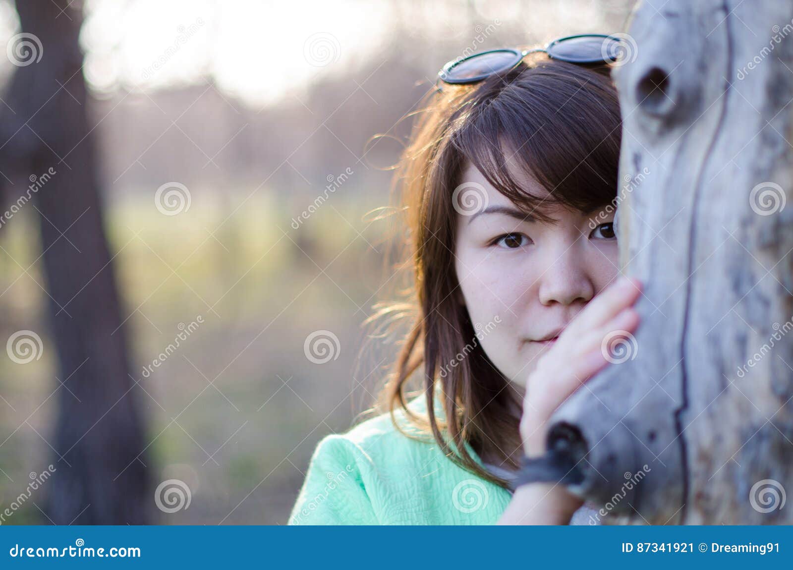 Beautiful Young Woman Hiding Behind a Tree Stock Image - Image of ...