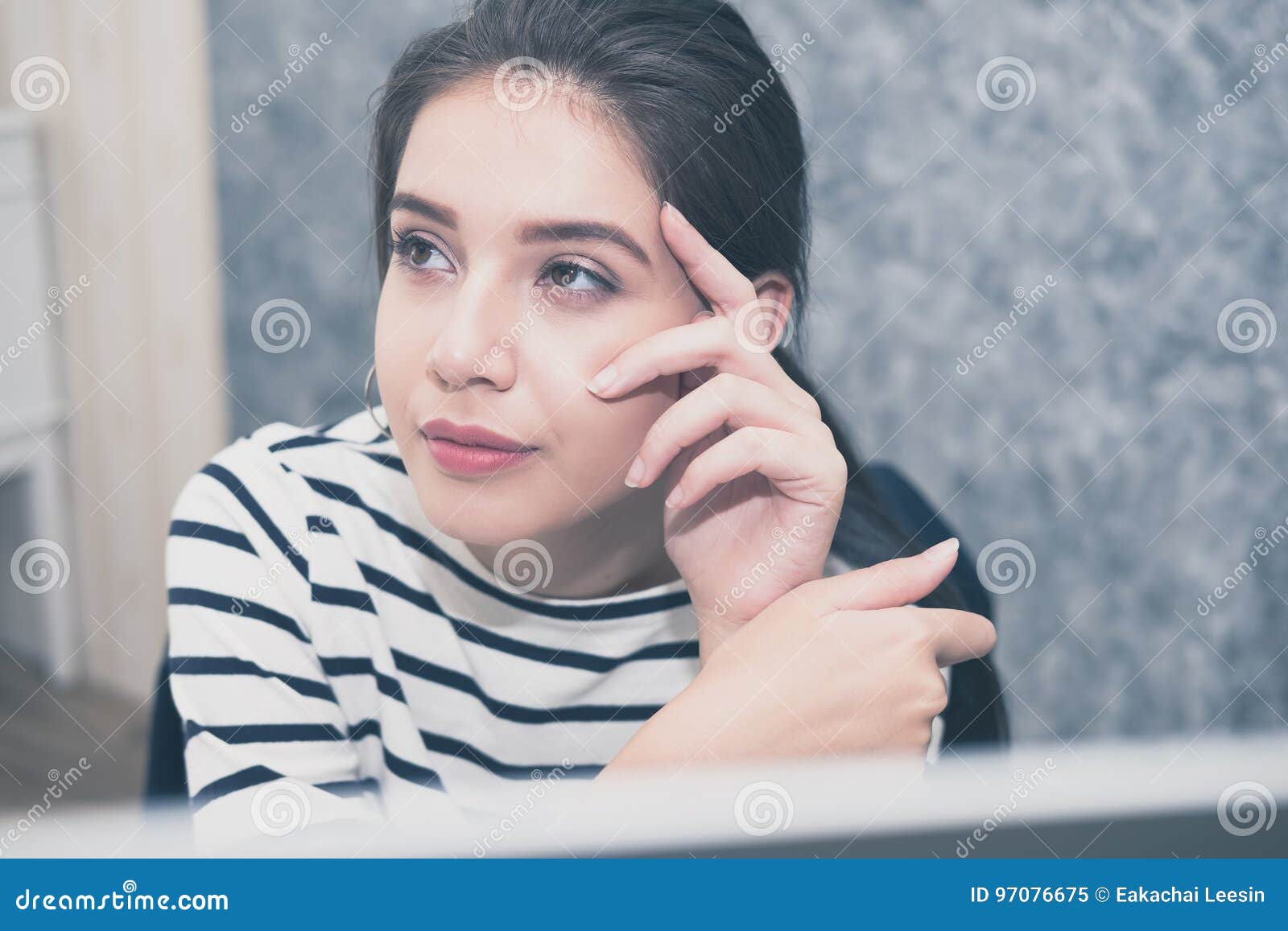 Beautiful Young Woman Looking at a Computer Screen and Thinking Stock ...