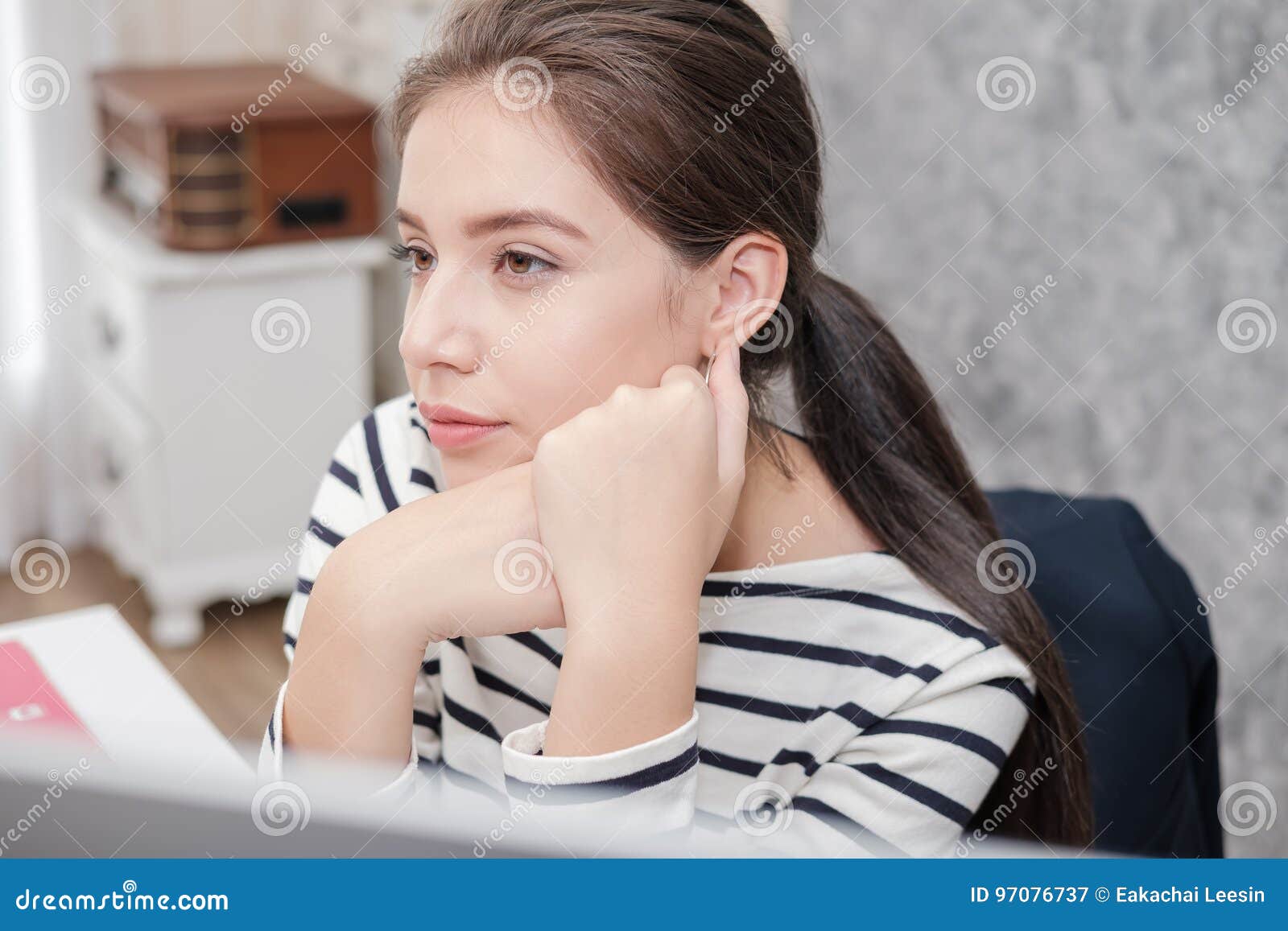 Beautiful Young Woman Looking at a Computer Screen and Thinking Stock ...