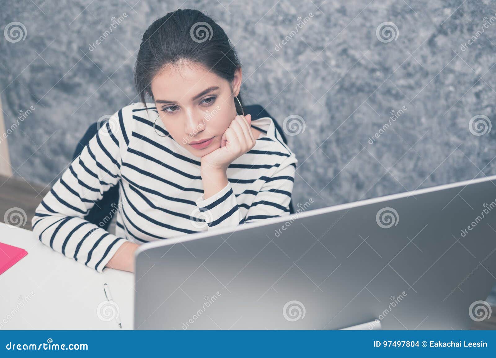 Beautiful Young Woman Looking at a Computer Screen and Thinking at the ...