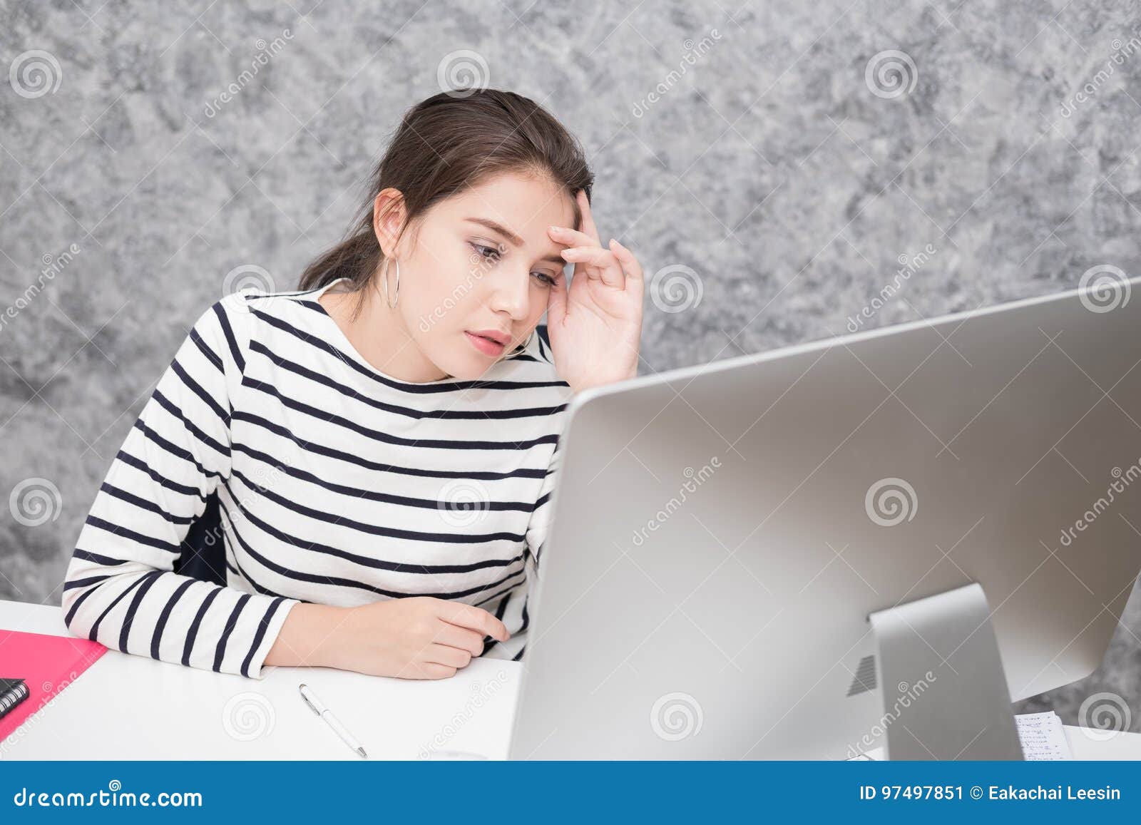 Beautiful Young Woman Looking at a Computer Screen and Thinking at the ...